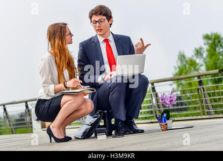 Junior executives dynamics working outside of their office Stock Photo ...