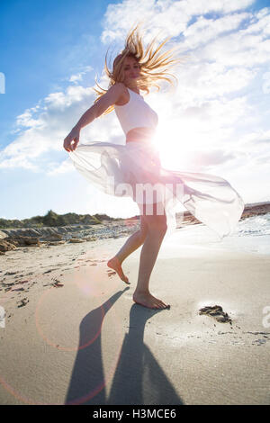 A woman dancing at the beach Stock Photo - Alamy