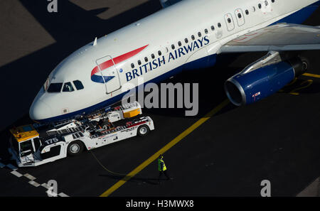 Ground staff work on the runway at London's Heathrow Airport Stock ...