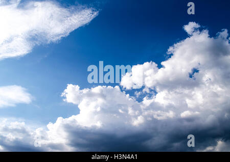 Heavy dark storm clouds covering the sky with patches of blue light ...