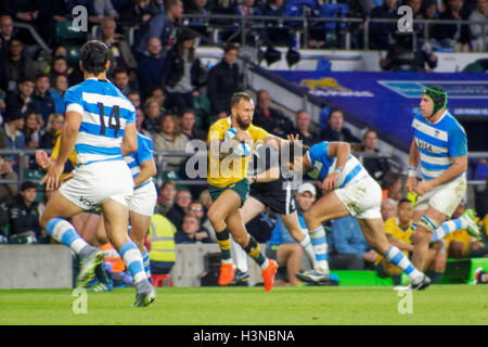 Australia's Quade Cooper (10) fends off a tackle during the rugby union ...