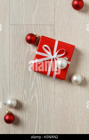 Christmas baubles and Christmas present. Bright paper background. Copy ...