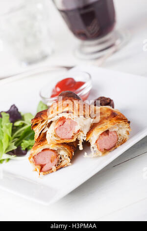 Frankfurter In Puff Pastry With Salad Stock Photo - Alamy