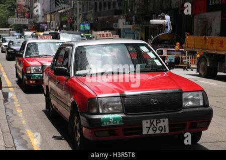 Red and white taxi moving through Hong Kong, China, Asia Stock Photo ...