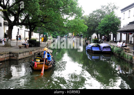 July 25, 2015. Tongli Town, China. A tourist boat moving by a coffee house on the water canals ...