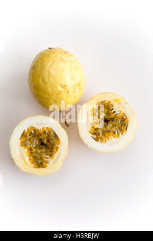 Close-up of a whole and split passion fruits (passionfruit, purple ...