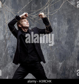 Young man pulling something behind him. Concept of manipulation and ...