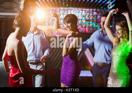 Smiling friends dancing on dance floor Stock Photo - Alamy