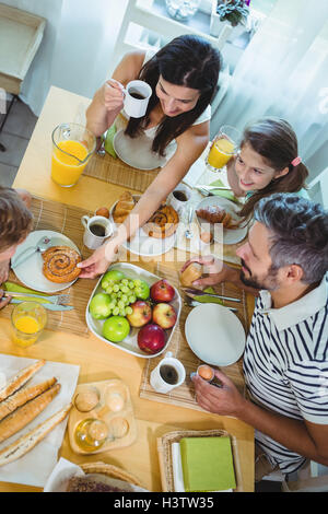 Happy family family having breakfast at home Stock Photo - Alamy