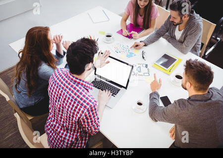 High-angle view of business partners working and communicating together ...