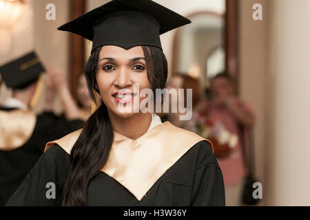 Graduate students wearing graduation hat and gown Stock Photo - Alamy