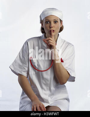 Nurse, gesture, silence, quiet, studio, half portrait, side view ...