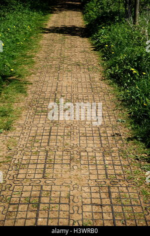 embedded grill matt placed on a footpath to provide grip for walkers ...
