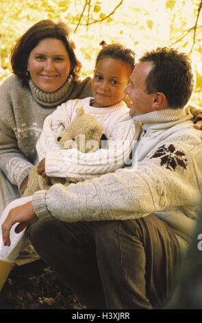 Happy adoptive family of adopted daughter child and woman mother smile ...