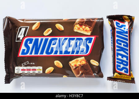Snickers chocolate bar on white background with open cut up bar by ...
