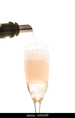 Festive party concept, Pour champagne from bottle into glass with peony ...