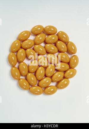 Yellow dragee pills Stock Photo - Alamy