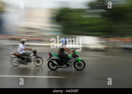 Slow camera shutter speed exaggerating movement of a multicab public ...