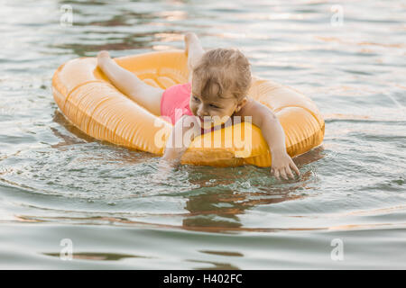 Girl lying on raft Stock Photo - Alamy