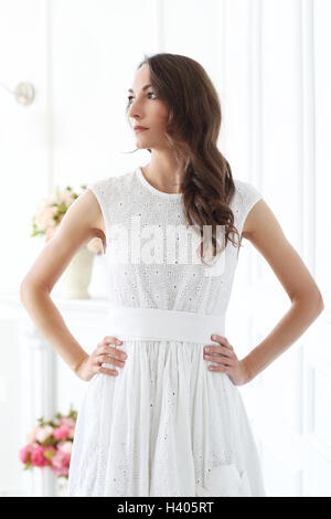 Woman in light white dress on wavy beach Stock Photo - Alamy