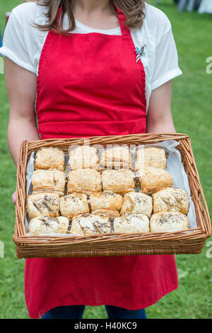 Woman in a red apron holding a knife in the kitchen. Cooking Stock ...
