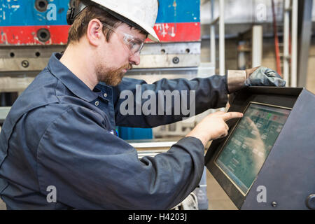 Worker using control panel Stock Photo - Alamy