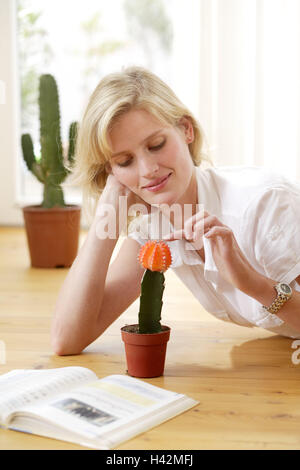 Woman, young, lie, indoor plants, cactus, sphere cactus, Ferocactus ...