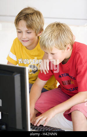 two boys play computer games at home Stock Photo - Alamy