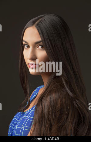 Portrait of contemporary mixed-race woman smiling at camera while ...