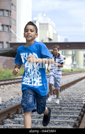 two boys run in railroad Stock Photo - Alamy