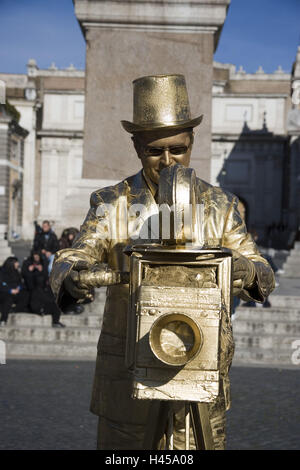 Italian street pantomime artist in grotesque wig, playing a bizarre one ...