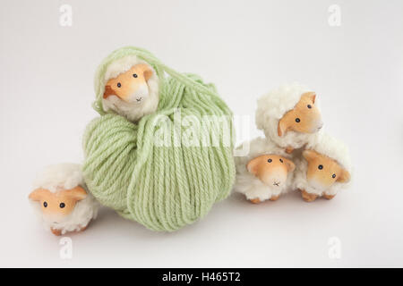 Cute sheep playing together with a ball of green wool Stock Photo - Alamy