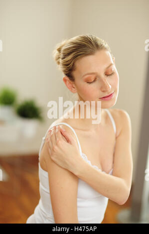 Portrait of a woman touches his shoulder with his hand white mask skin ...