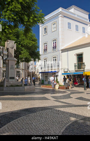 Lagos Portugal old town square with purple jacaranda trees and people ...