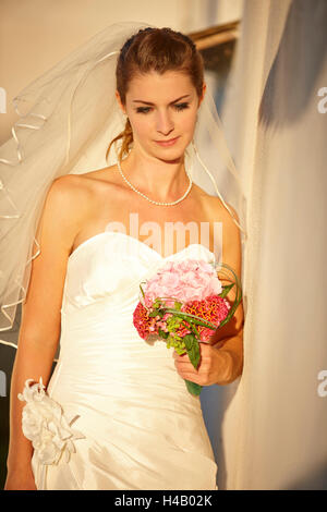 MODEL RELEASED Portrait of a bride in wedding dress with shadow of the ...