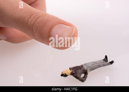 Hand threating to smash human figure on a white background Stock Photo ...