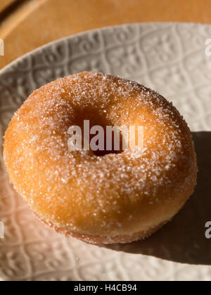 Powdered icing sugar ring donut, A glazed, yeast raised, American style ...