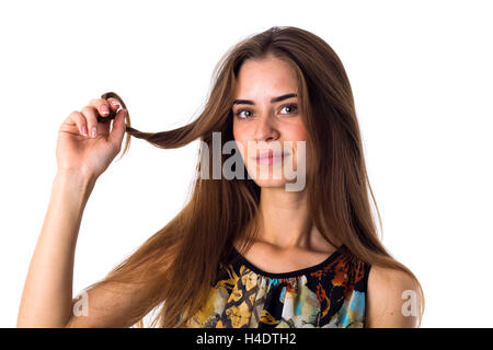 smiling young woman holding her strand of hair Stock Photo - Alamy
