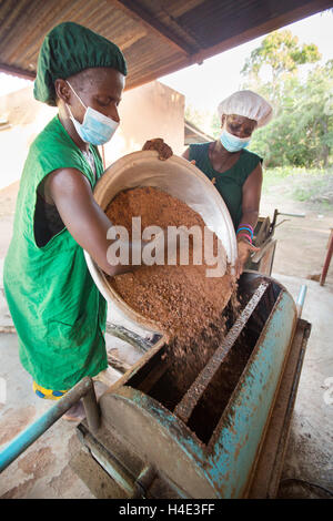 Employees process shea nuts into shea butter at a fair trade production ...