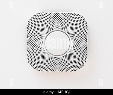 Modern smart home fire alarm installed on wall in room Stock Photo - Alamy