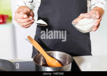Man sifting sugar in the pan Stock Photo - Alamy