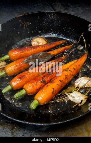 carrots cooking in a shallow frying pan Stock Photo - Alamy