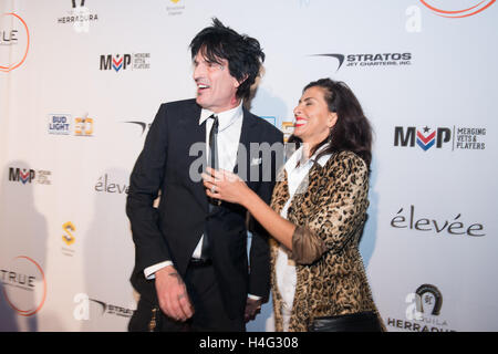 Tommy Lee poses with his fiance Sofia Toufa for a photo at the Glazer ...