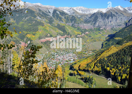 view of Telluride in the fall with yellow aspen and snow covered ...