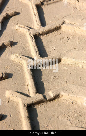 Tractor wheel tracks on wet mud Stock Photo - Alamy