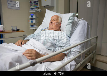 Elderly man (83) recovering in his hospital bed in the cardiac ward ...