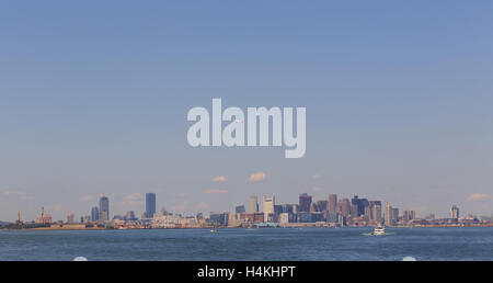 A photograph of a plane flying over the Boston Skyline, as seen from a ...