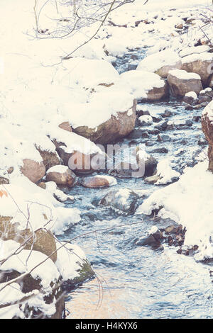 Winter stream with stones and snow. A beautiful winter concept for ...