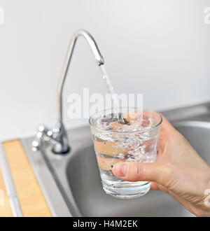 Blue water filter with glass on grey background Stock Photo - Alamy
