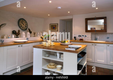 Interior of an English cottage with period furniture and floral display ...